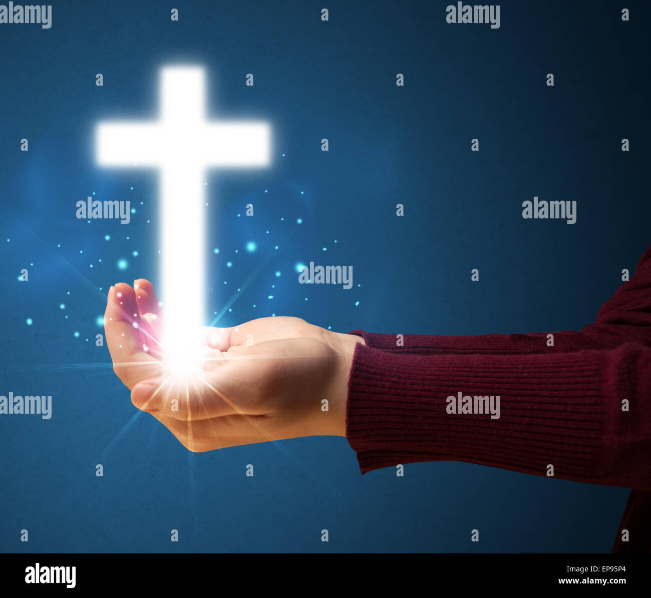 Glowing cross in the hand of a woman Stock Photo - Alamy