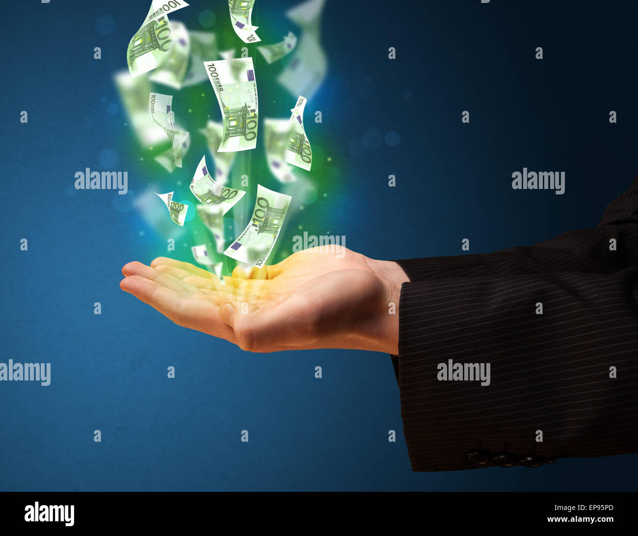 Glowing money in the hand of a businessman Stock Photo - Alamy