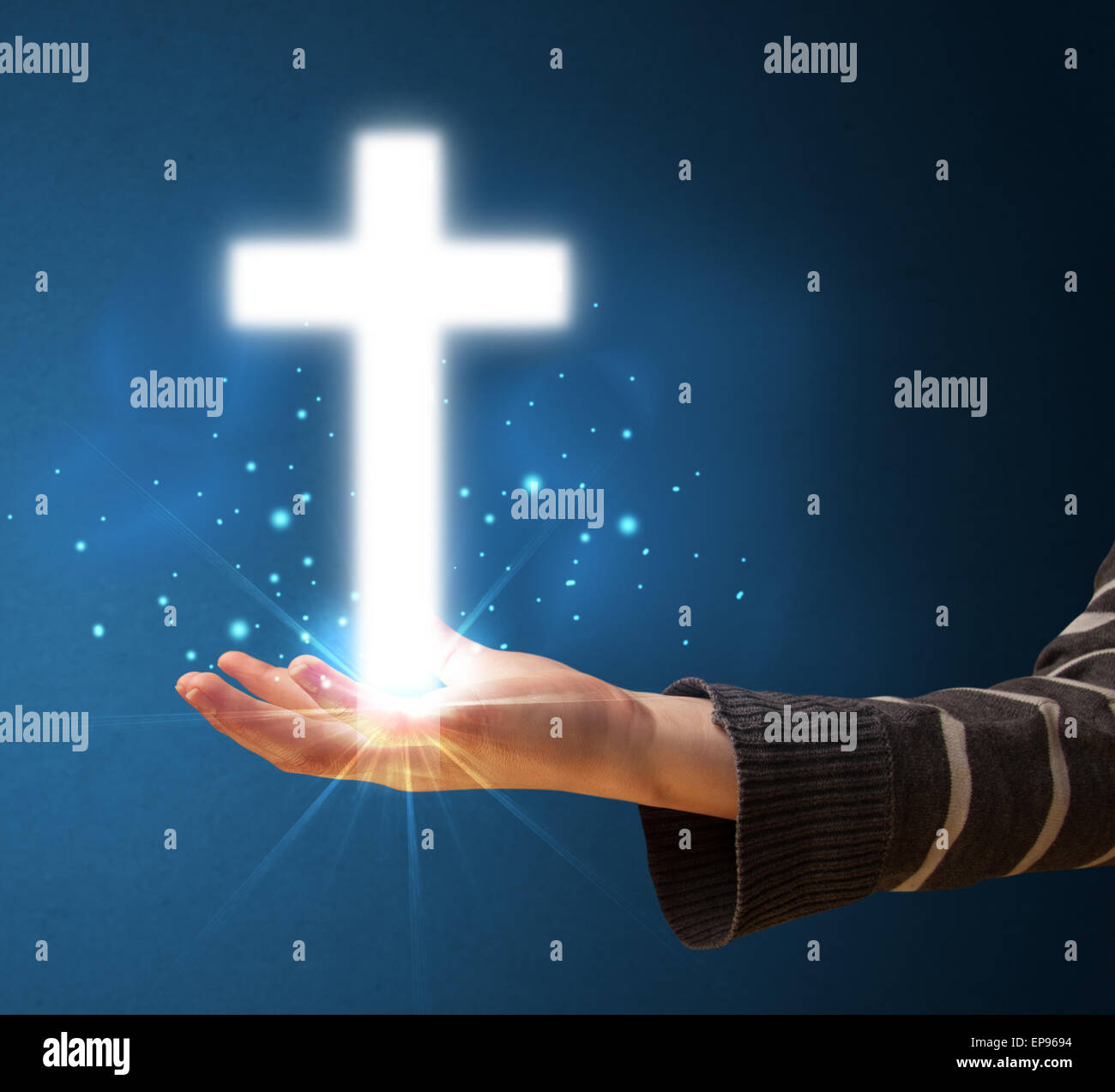 Glowing cross in the hand of a woman Stock Photo - Alamy