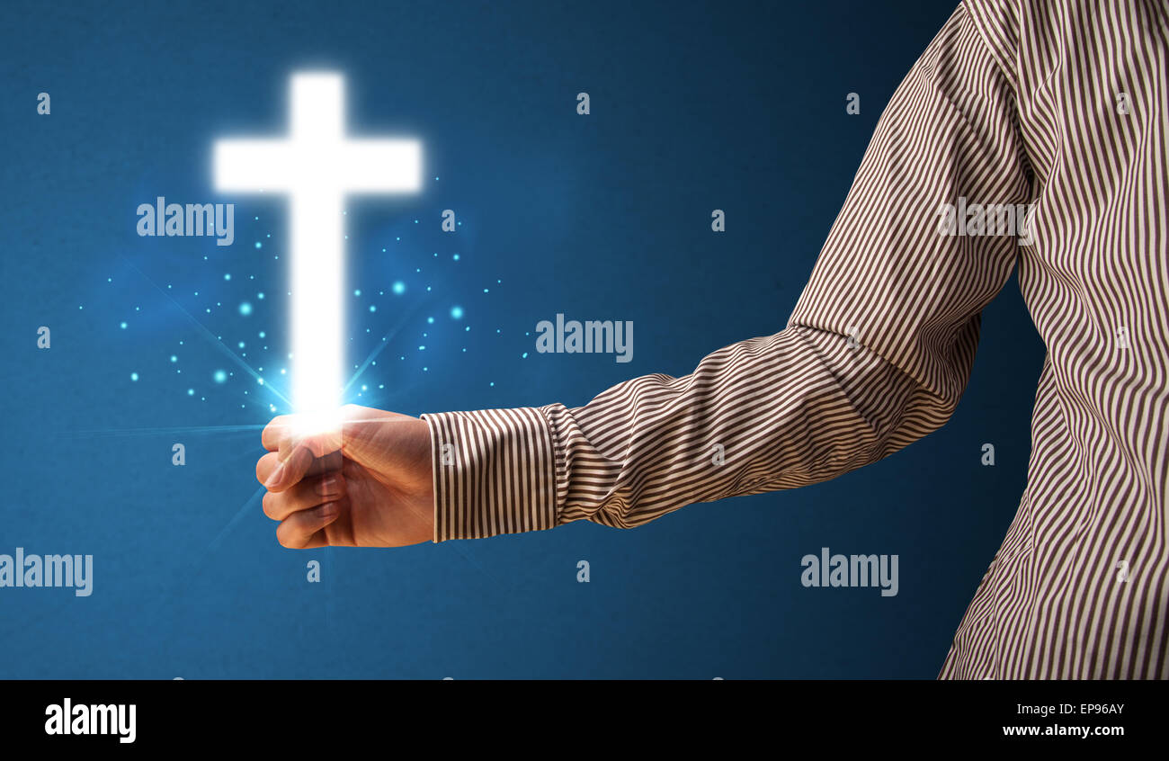 Glowing cross in the hand of a businessman Stock Photo - Alamy