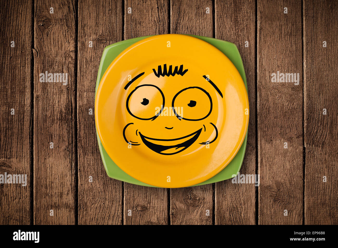 Happy smiley cartoon face on colorful dish plate Stock Photo - Alamy