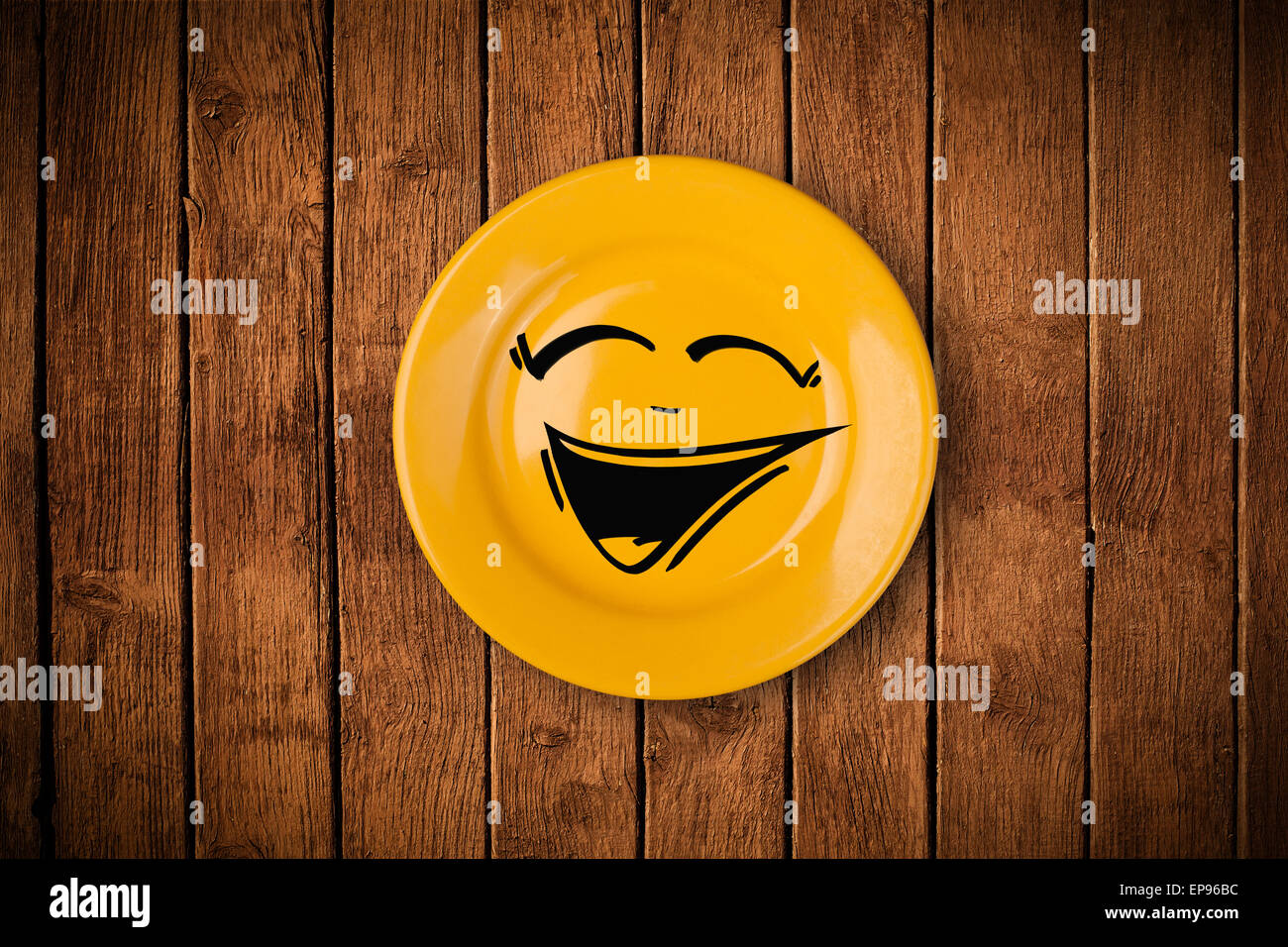 Happy smiley cartoon face on colorful dish plate Stock Photo - Alamy