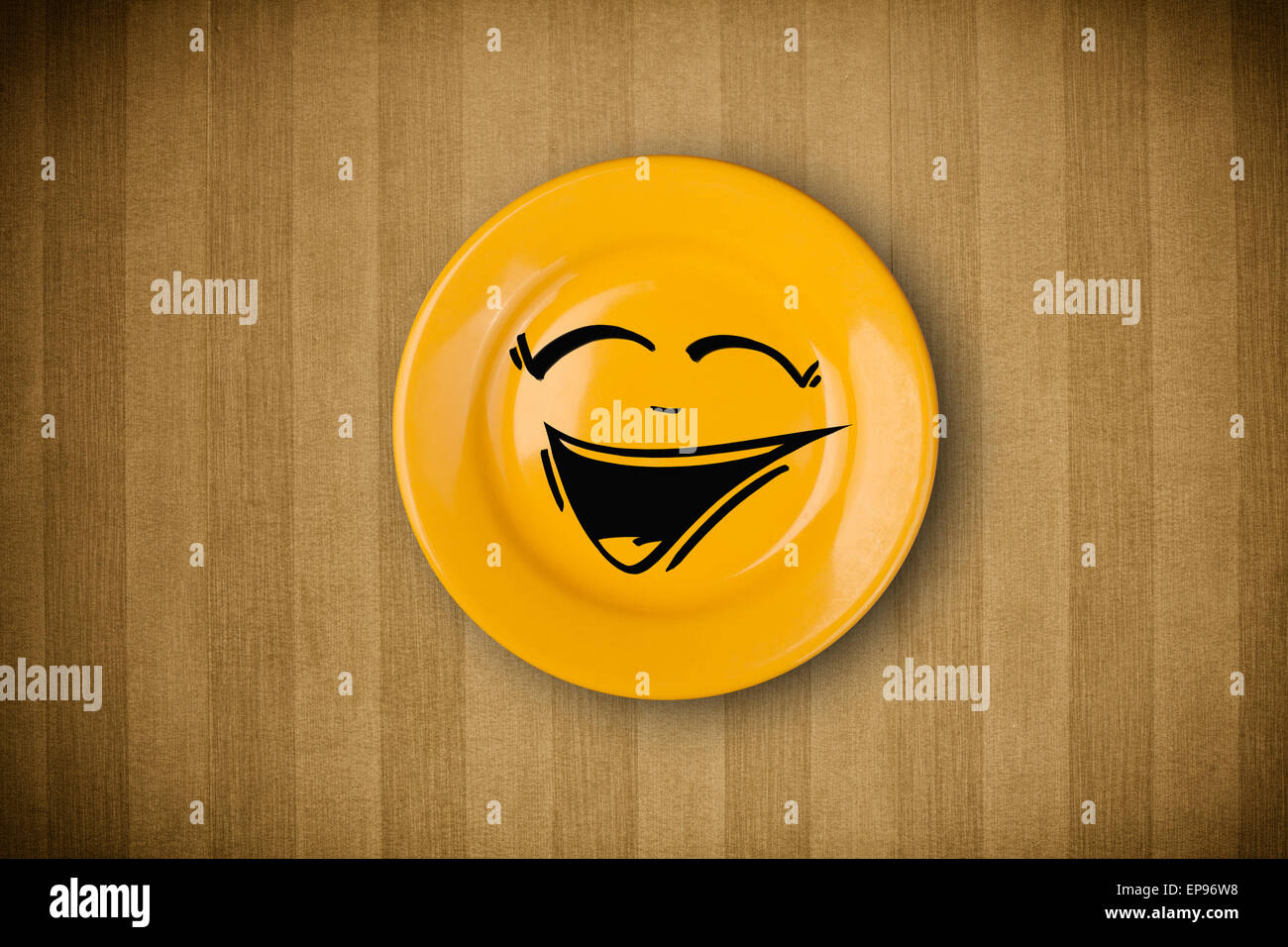 Happy smiley cartoon face on colorful dish plate Stock Photo - Alamy