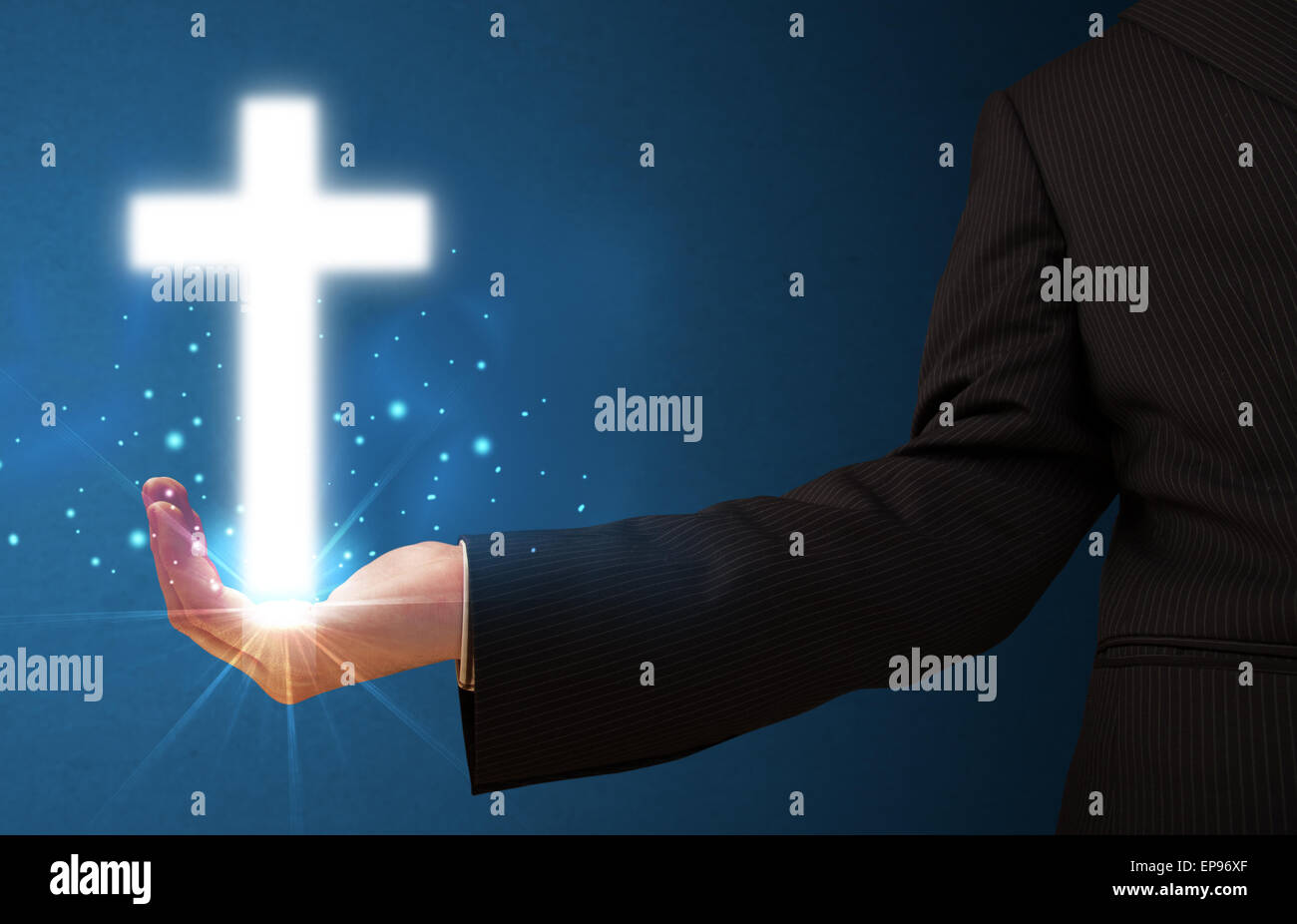 Glowing cross in the hand of a businessman Stock Photo - Alamy