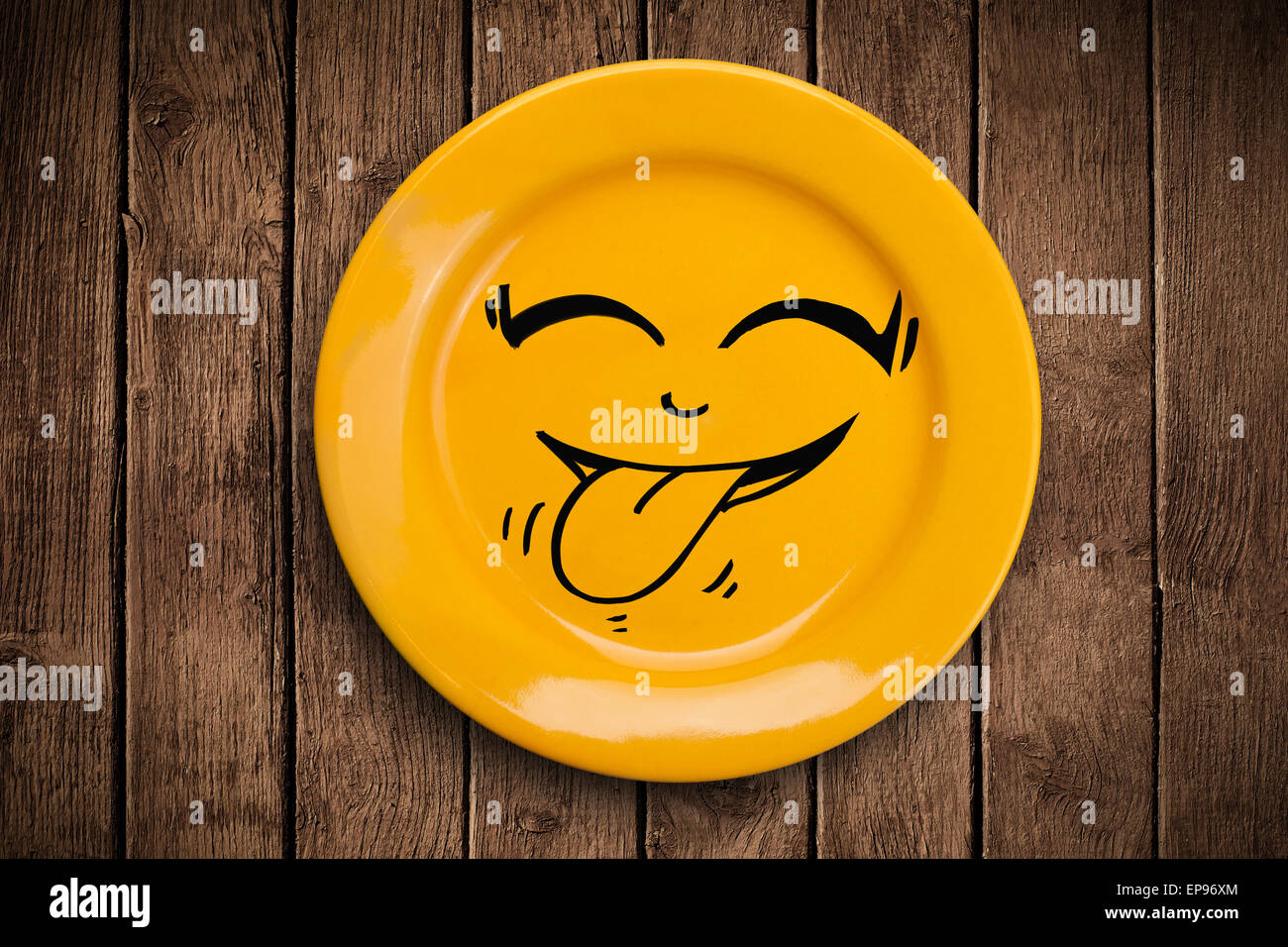 Happy smiley cartoon face on colorful dish plate Stock Photo - Alamy