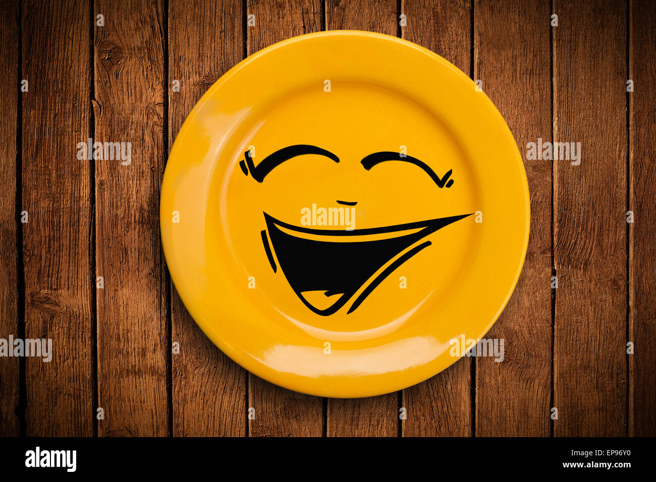 Happy smiley cartoon face on colorful dish plate Stock Photo - Alamy