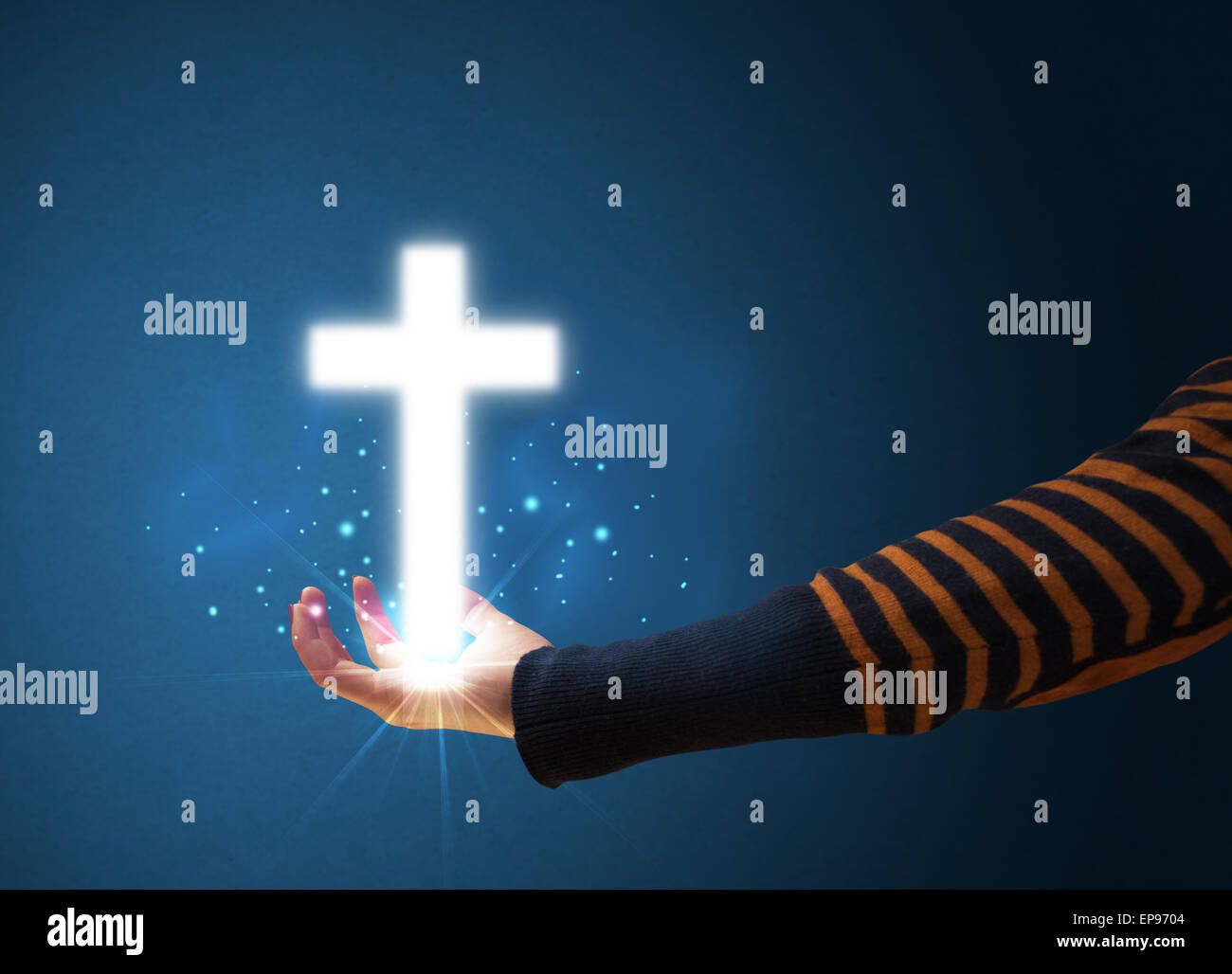 Glowing cross in the hand of a woman Stock Photo - Alamy