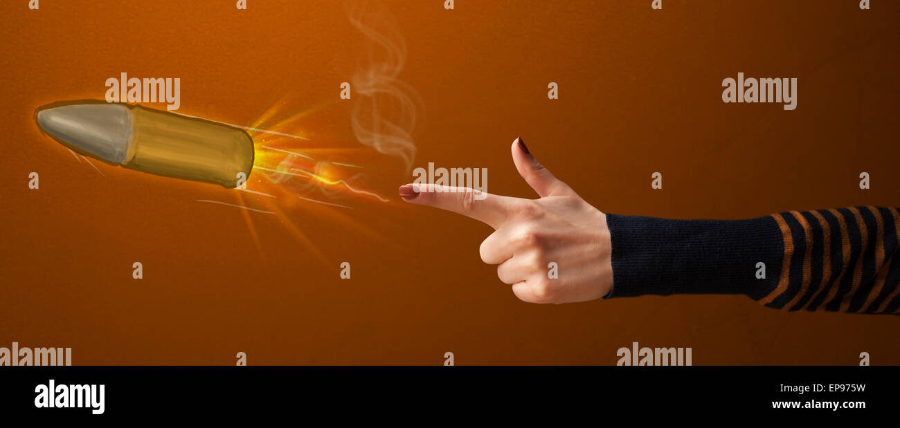 Gun shaped woman hand with bullet Stock Photo - Alamy