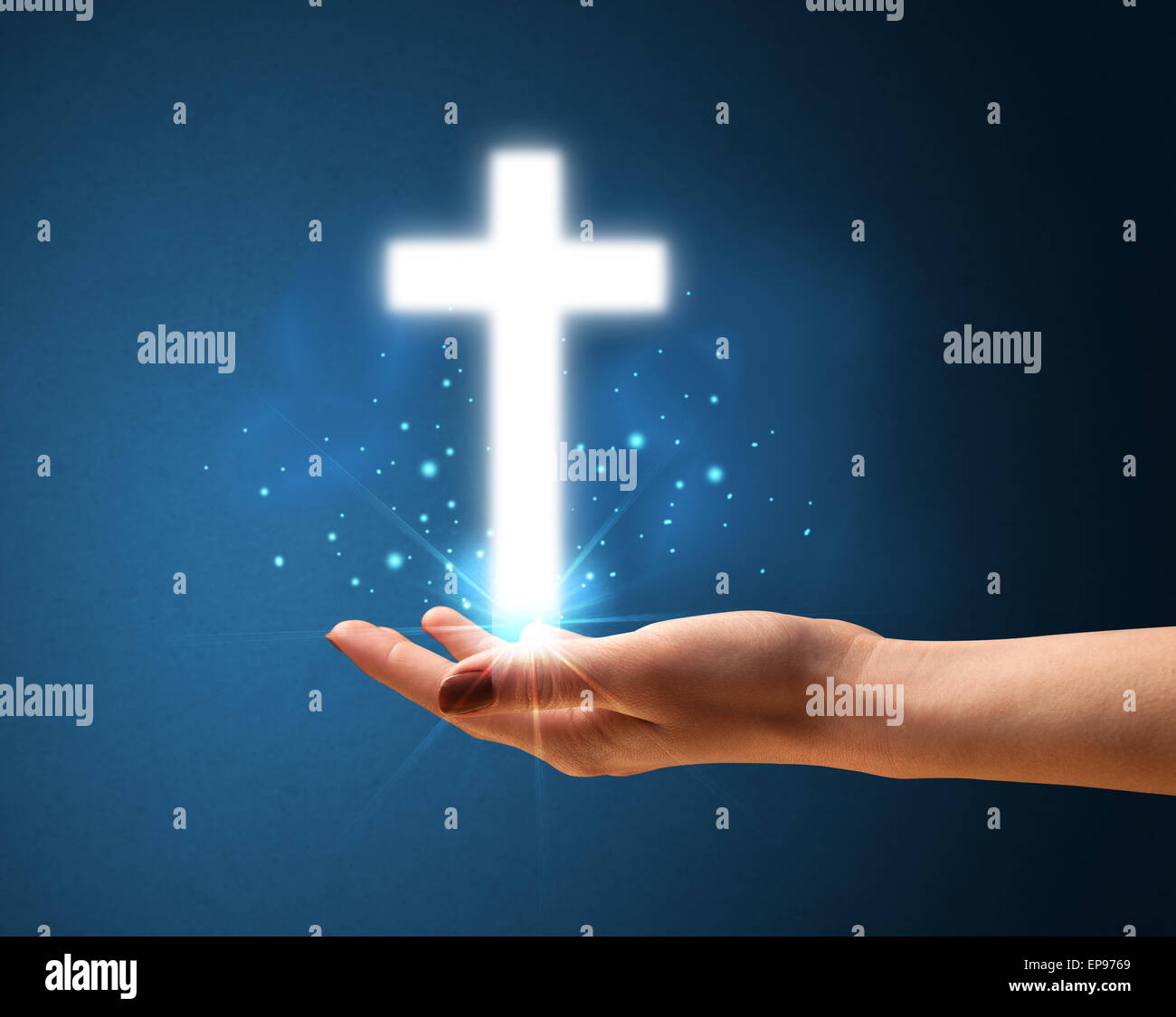 Glowing cross in the hand of a woman Stock Photo - Alamy