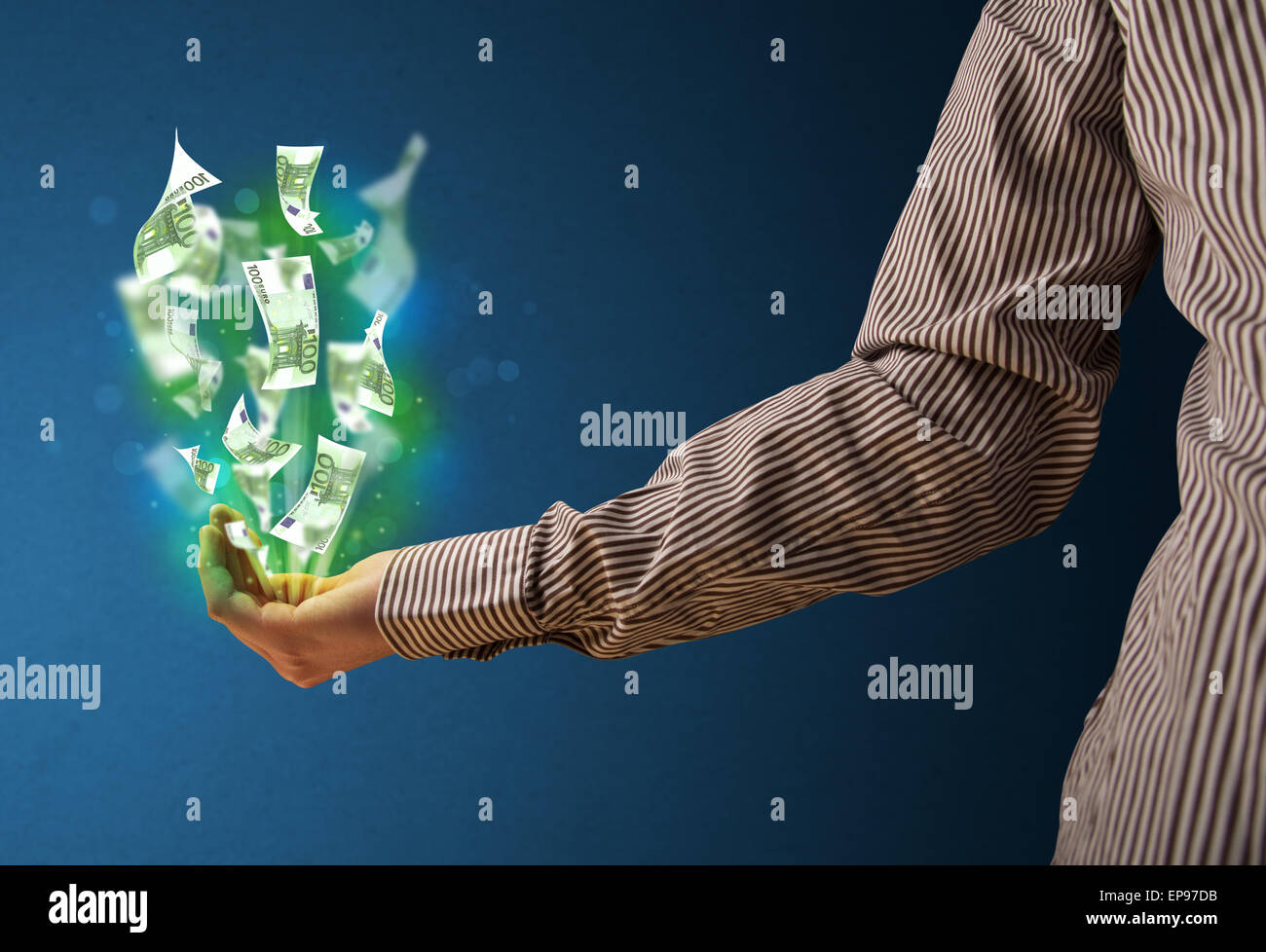 Glowing money in the hand of a businessman Stock Photo - Alamy