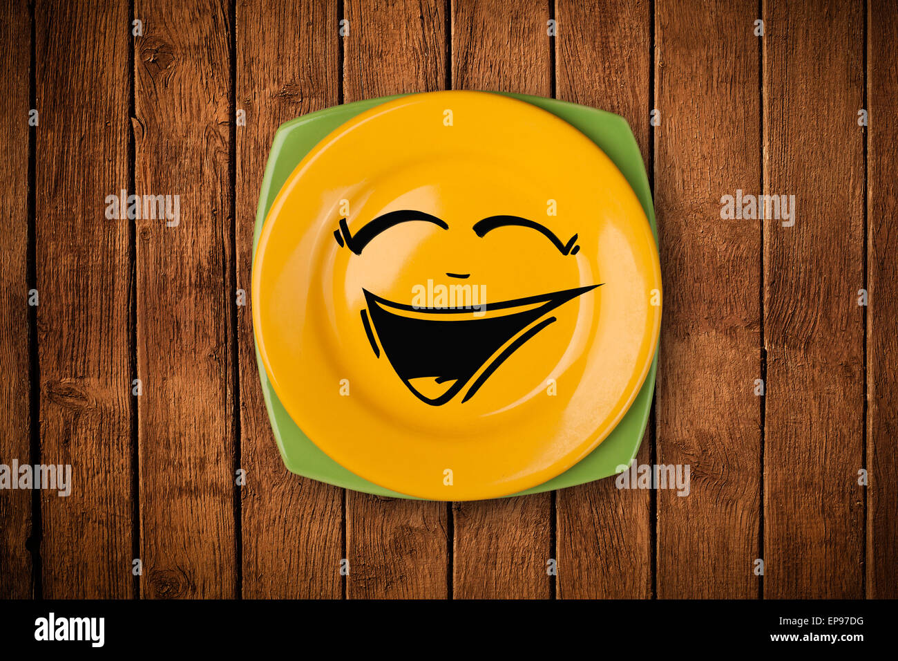 Happy smiley cartoon face on colorful dish plate Stock Photo - Alamy