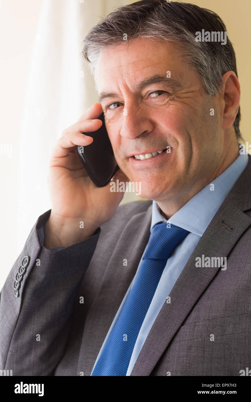 Smiling man calling someone with his mobile phone Stock Photo - Alamy