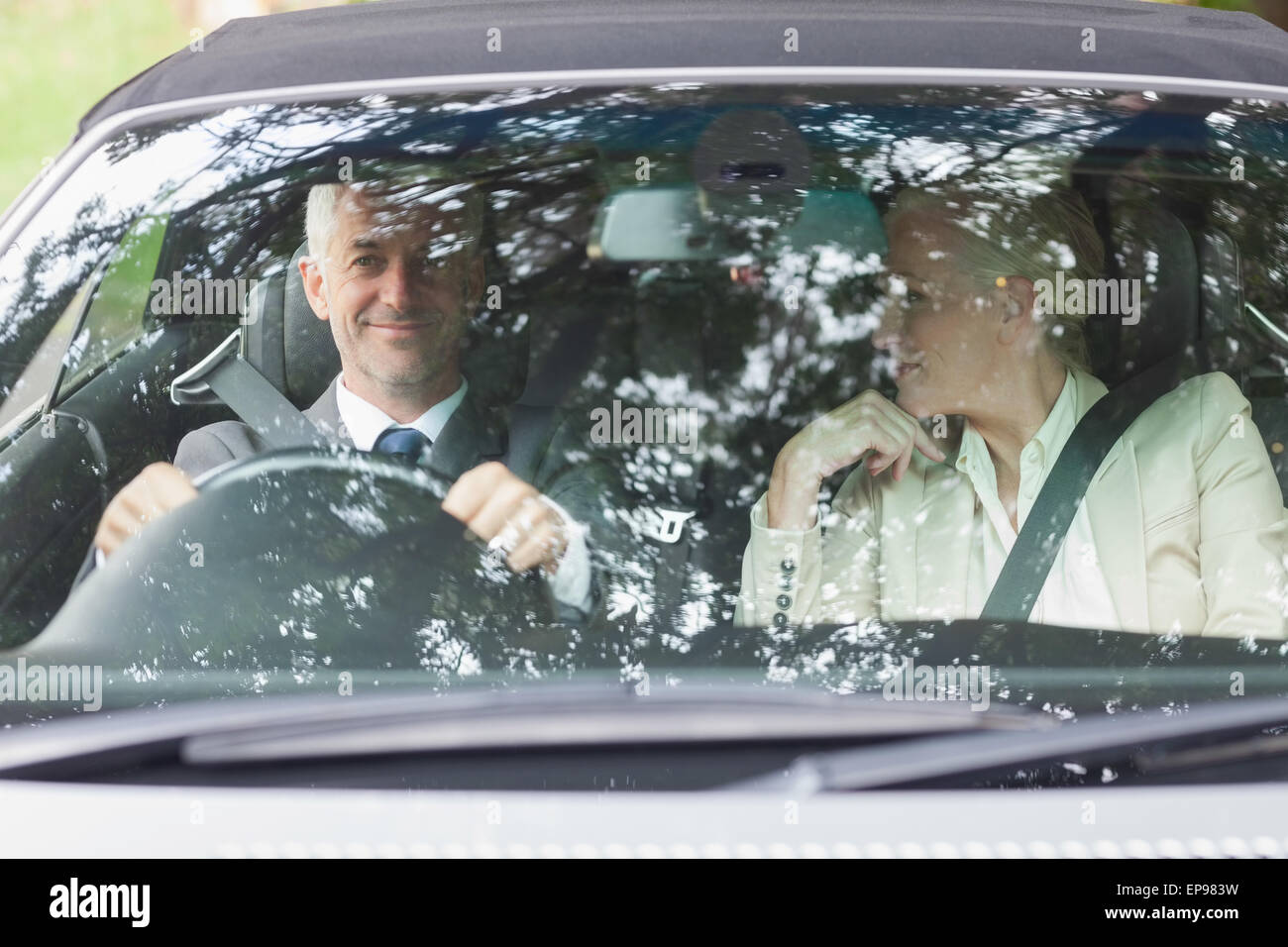 Smiling business people having a ride in classy car Stock Photo - Alamy