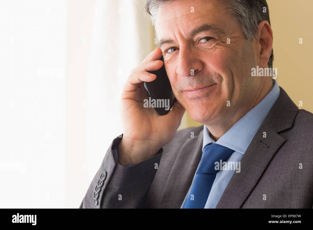 Content man calling someone with his mobile phone Stock Photo - Alamy