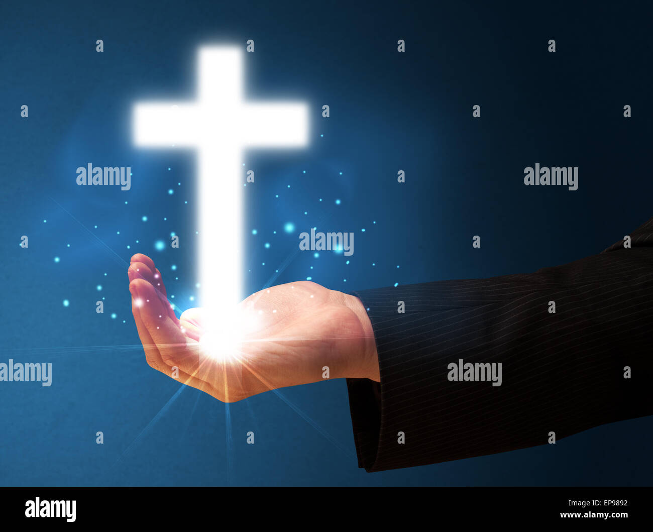 Glowing cross in the hand of a businessman Stock Photo - Alamy