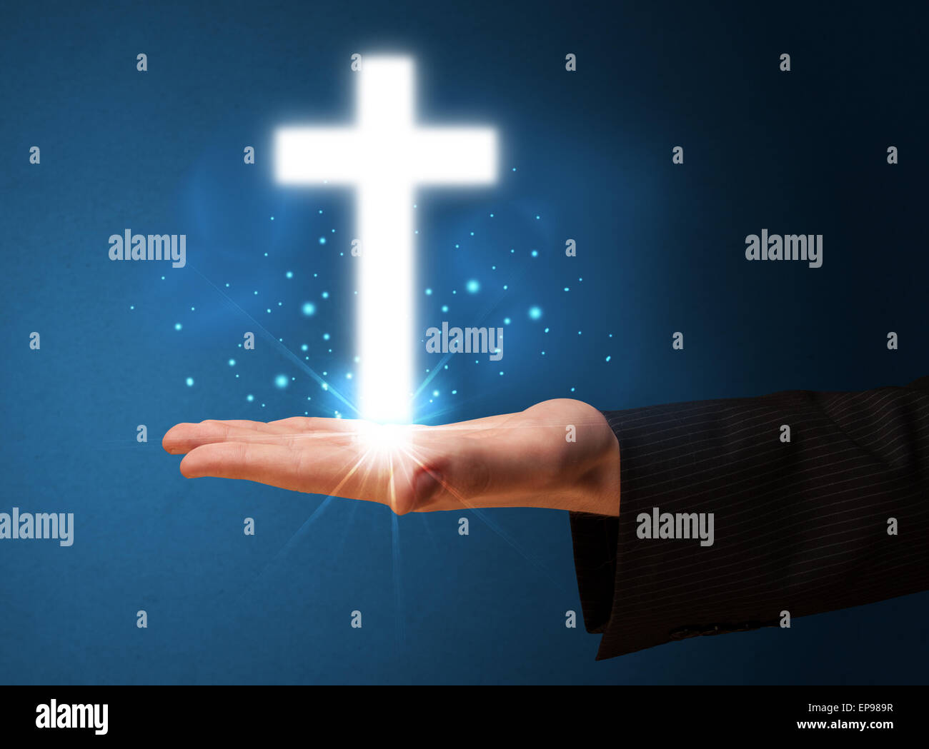 Glowing cross in the hand of a businessman Stock Photo - Alamy
