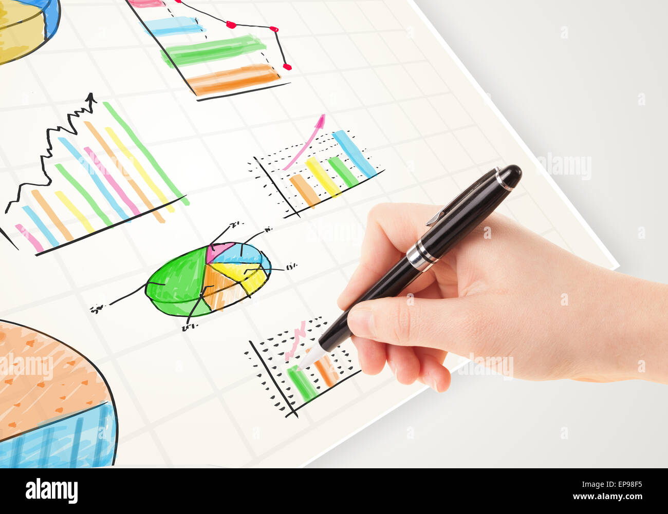 Business person drawing colorful graphs and icons on paper Stock Photo ...