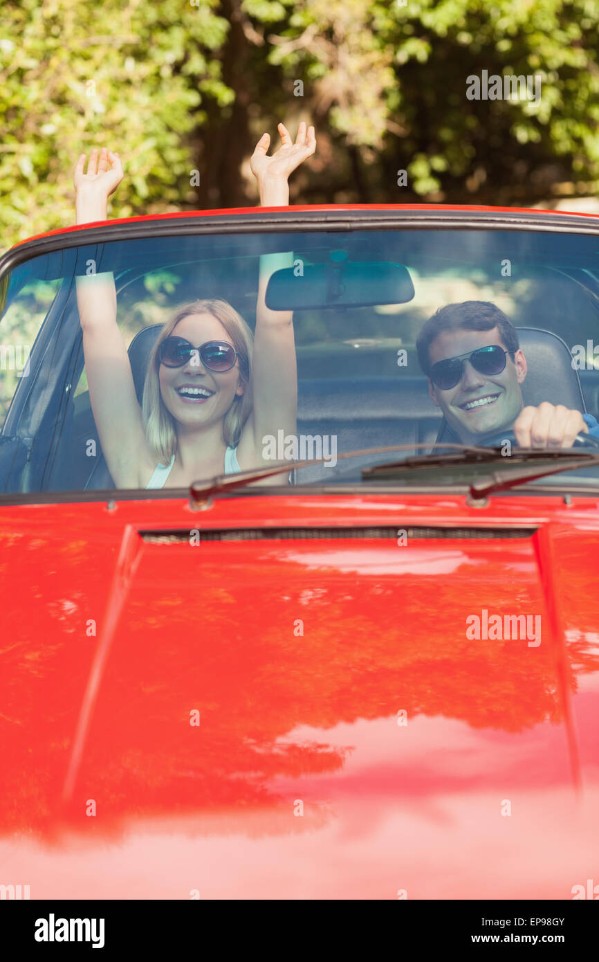 Loving couple having fun in their red cabriolet Stock Photo - Alamy
