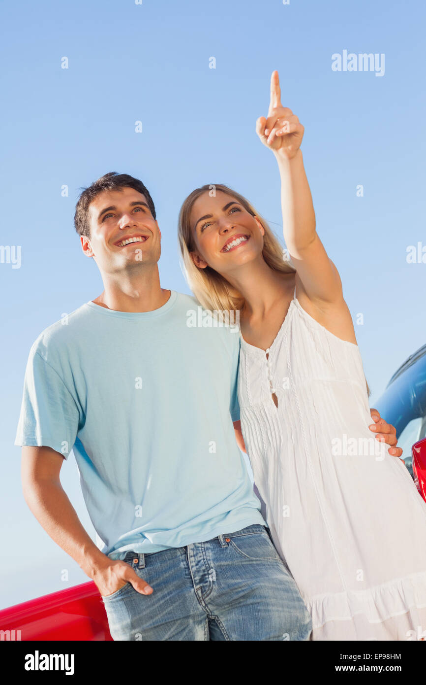 Happy woman showing something to her handsome boyfriend Stock Photo - Alamy
