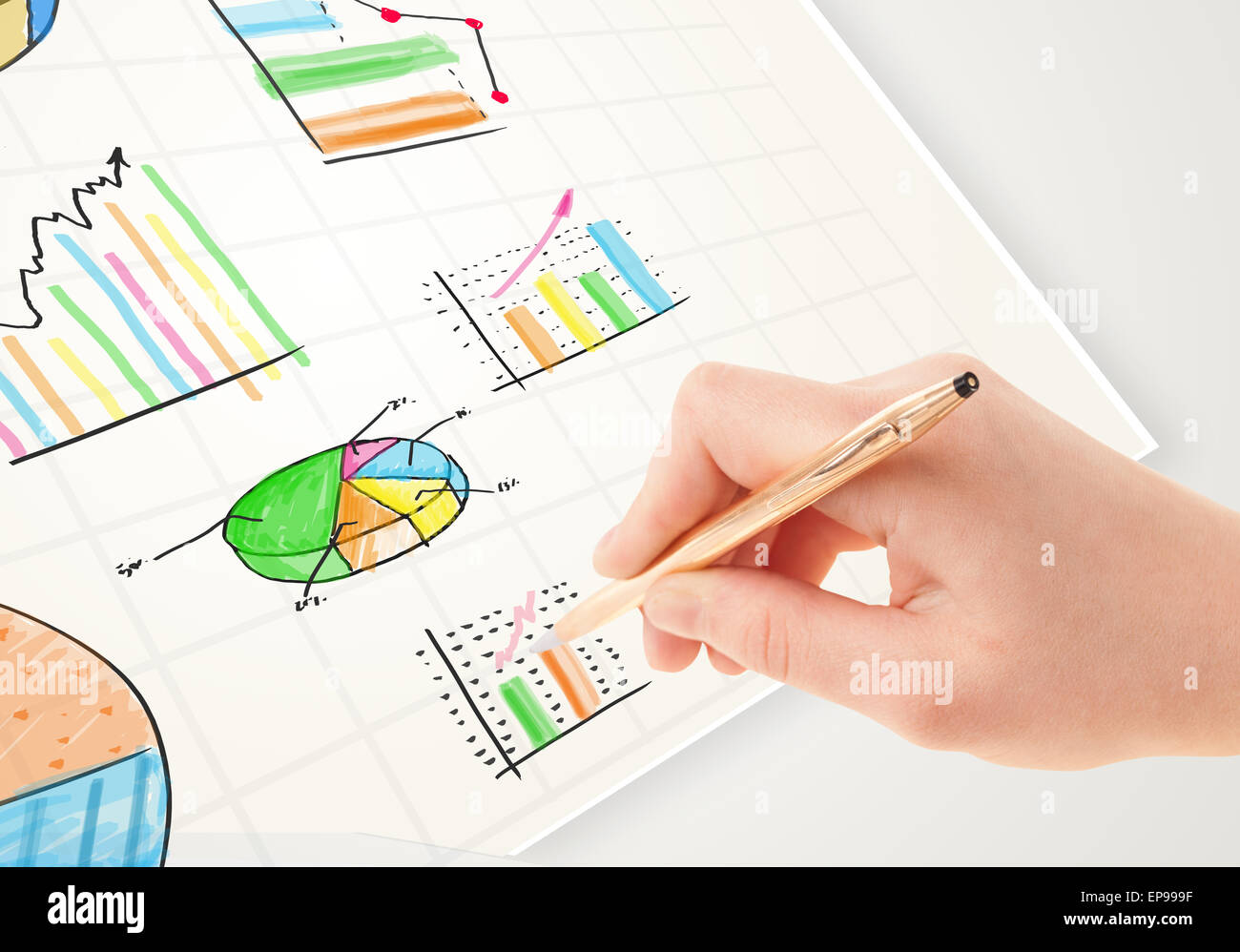 Business person drawing colorful graphs and icons on paper Stock Photo ...