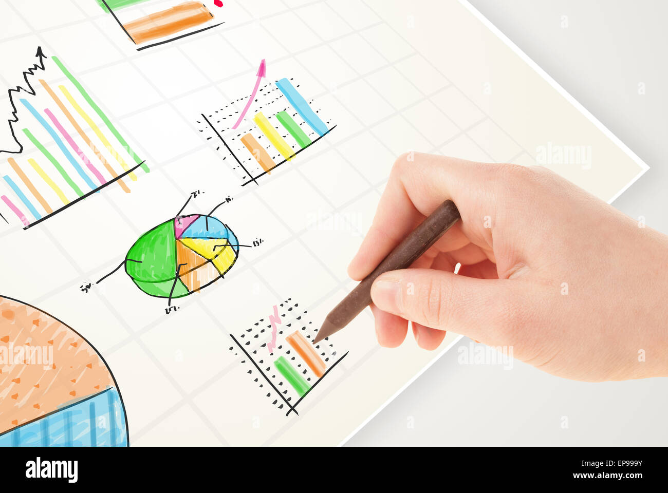 Business person drawing colorful graphs and icons on paper Stock Photo ...