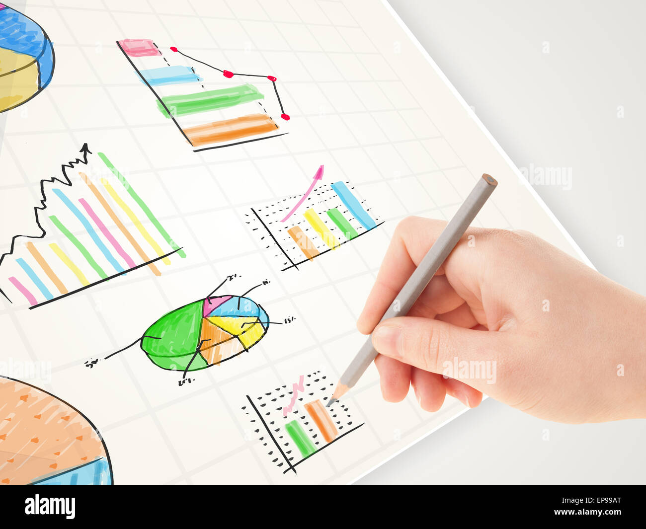 Business person drawing colorful graphs and icons on paper Stock Photo ...