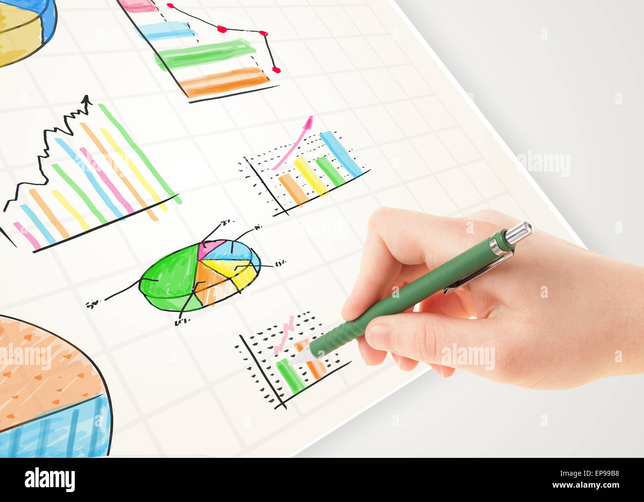 Business person drawing colorful graphs and icons on paper Stock Photo ...