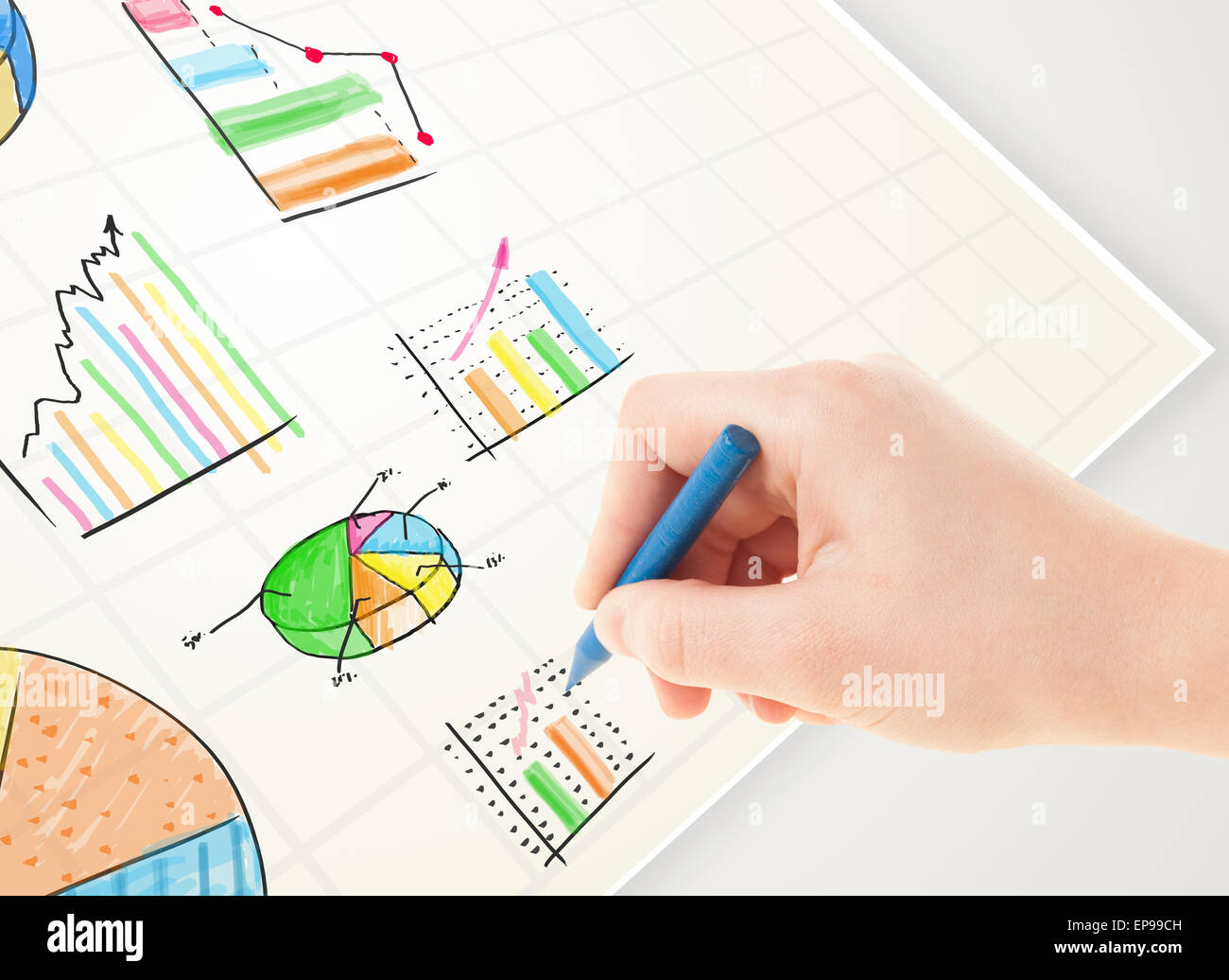 Business person drawing colorful graphs and icons on paper Stock Photo ...