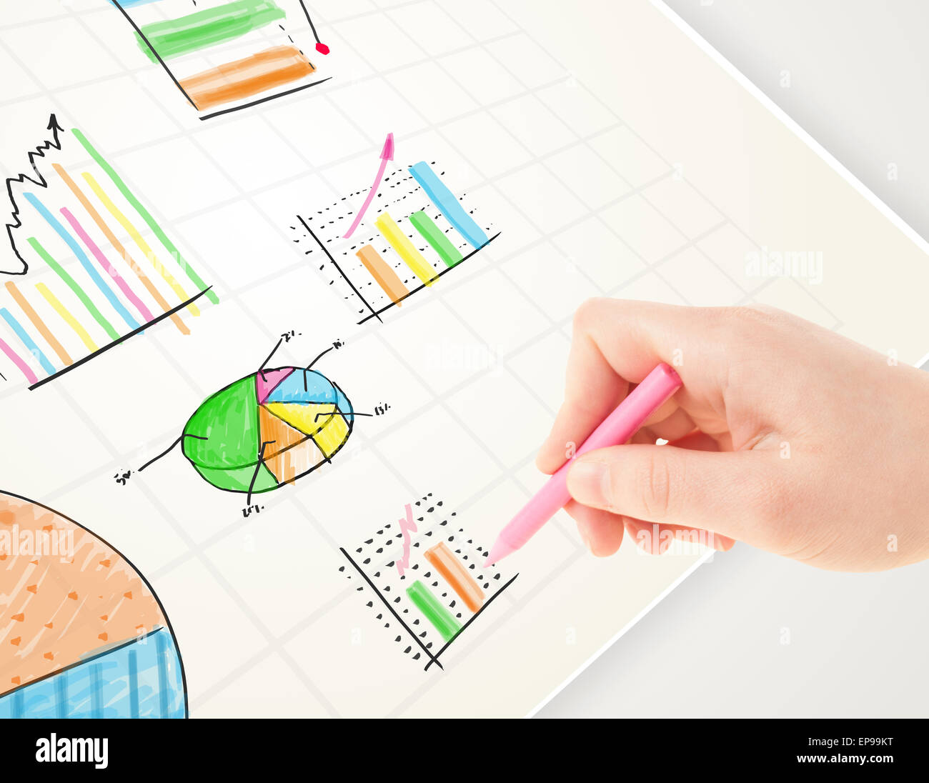 Business person drawing colorful graphs and icons on paper Stock Photo ...