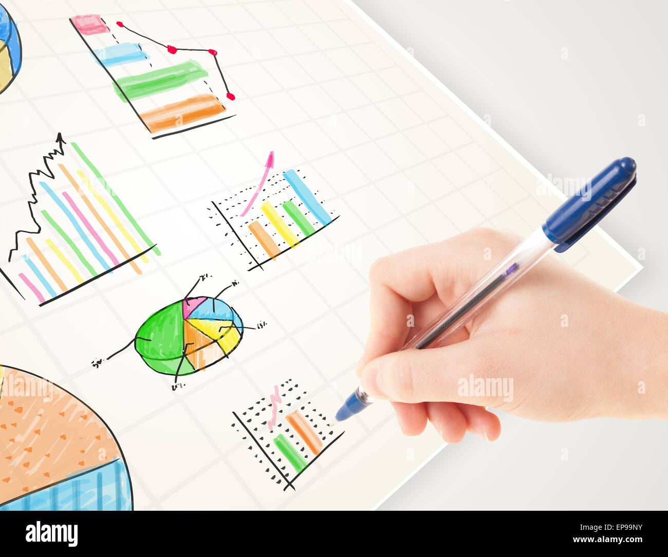 Business person drawing colorful graphs and icons on paper Stock Photo ...