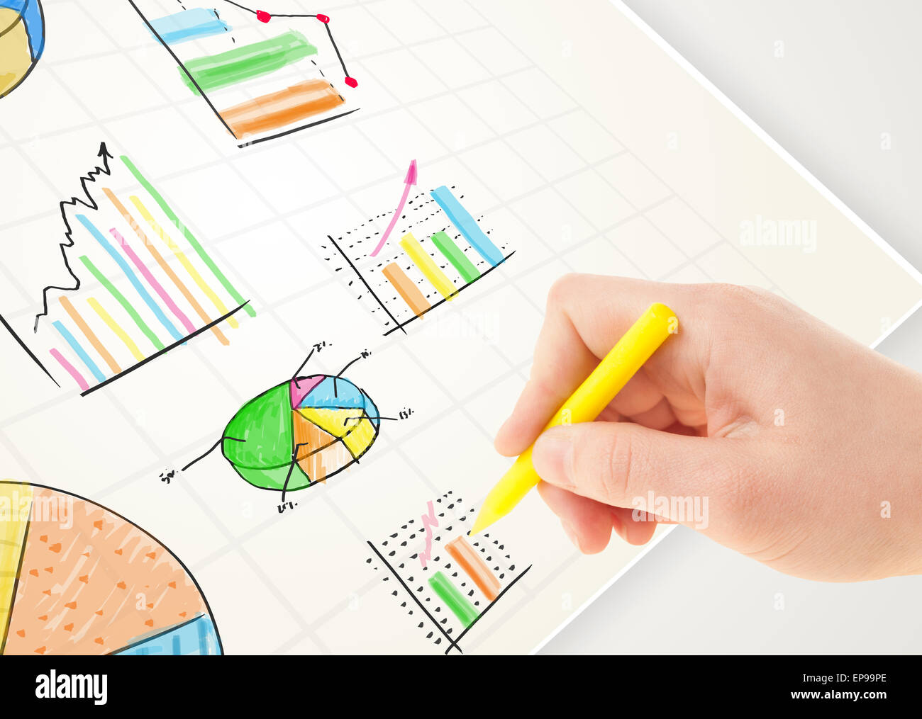 Business person drawing colorful graphs and icons on paper Stock Photo ...