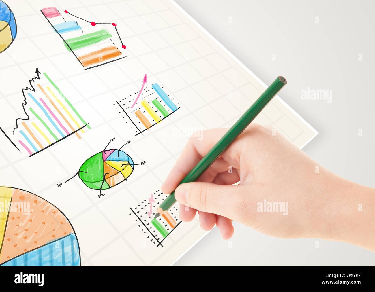 Business person drawing colorful graphs and icons on paper Stock Photo ...