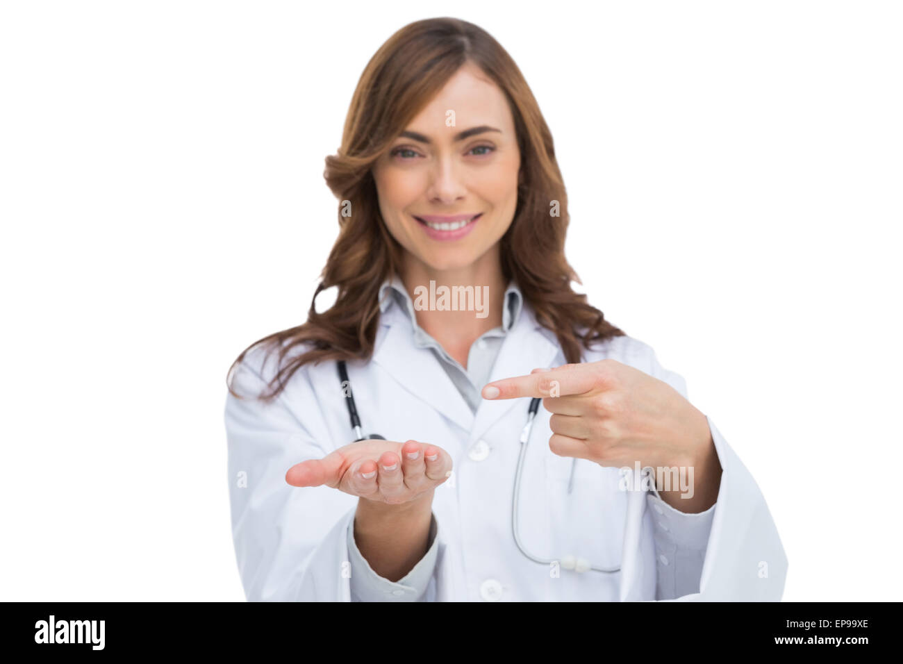 Smiling doctor pointing at something in her hand Stock Photo - Alamy