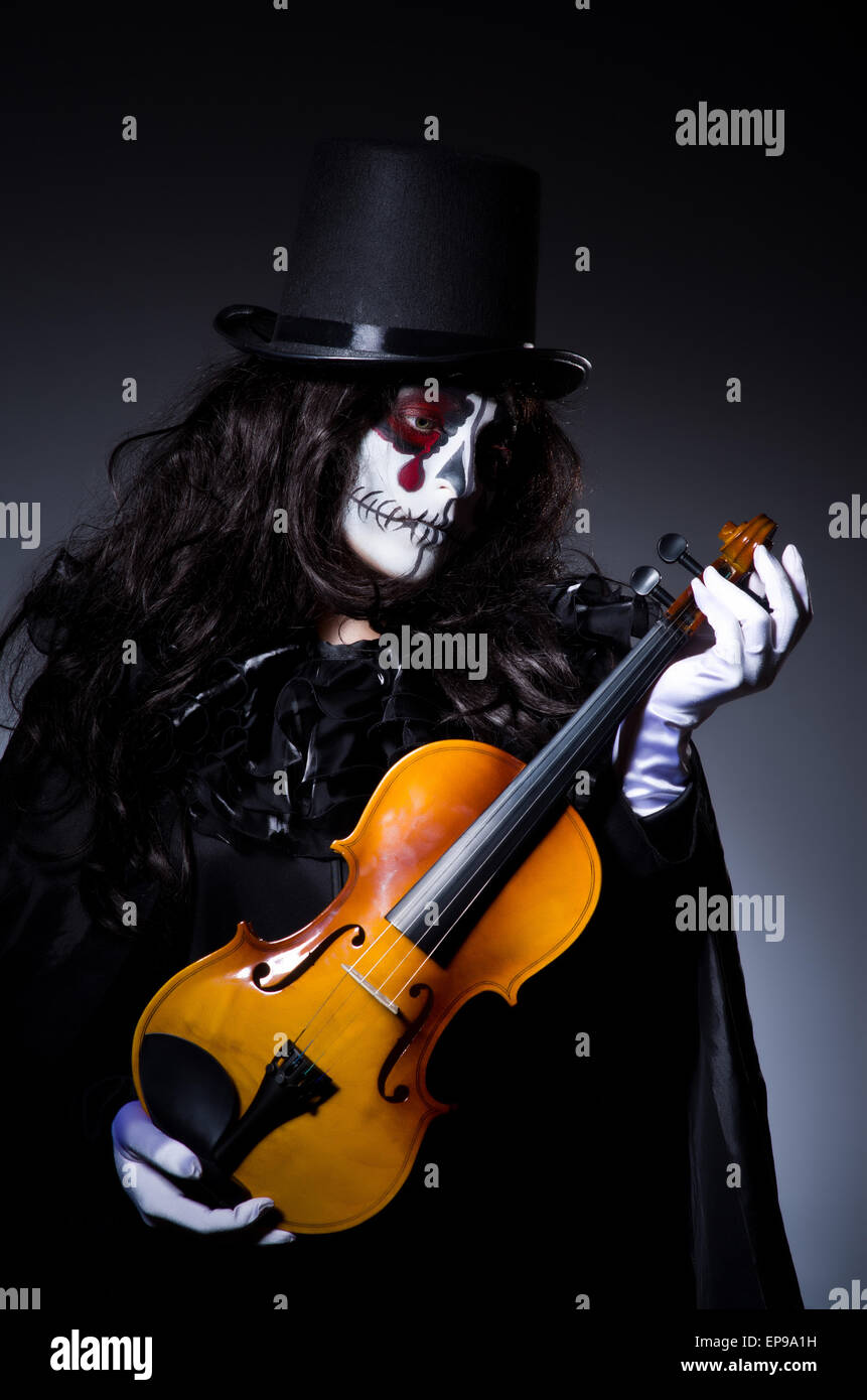 Monster playing violin in dark room Stock Photo - Alamy
