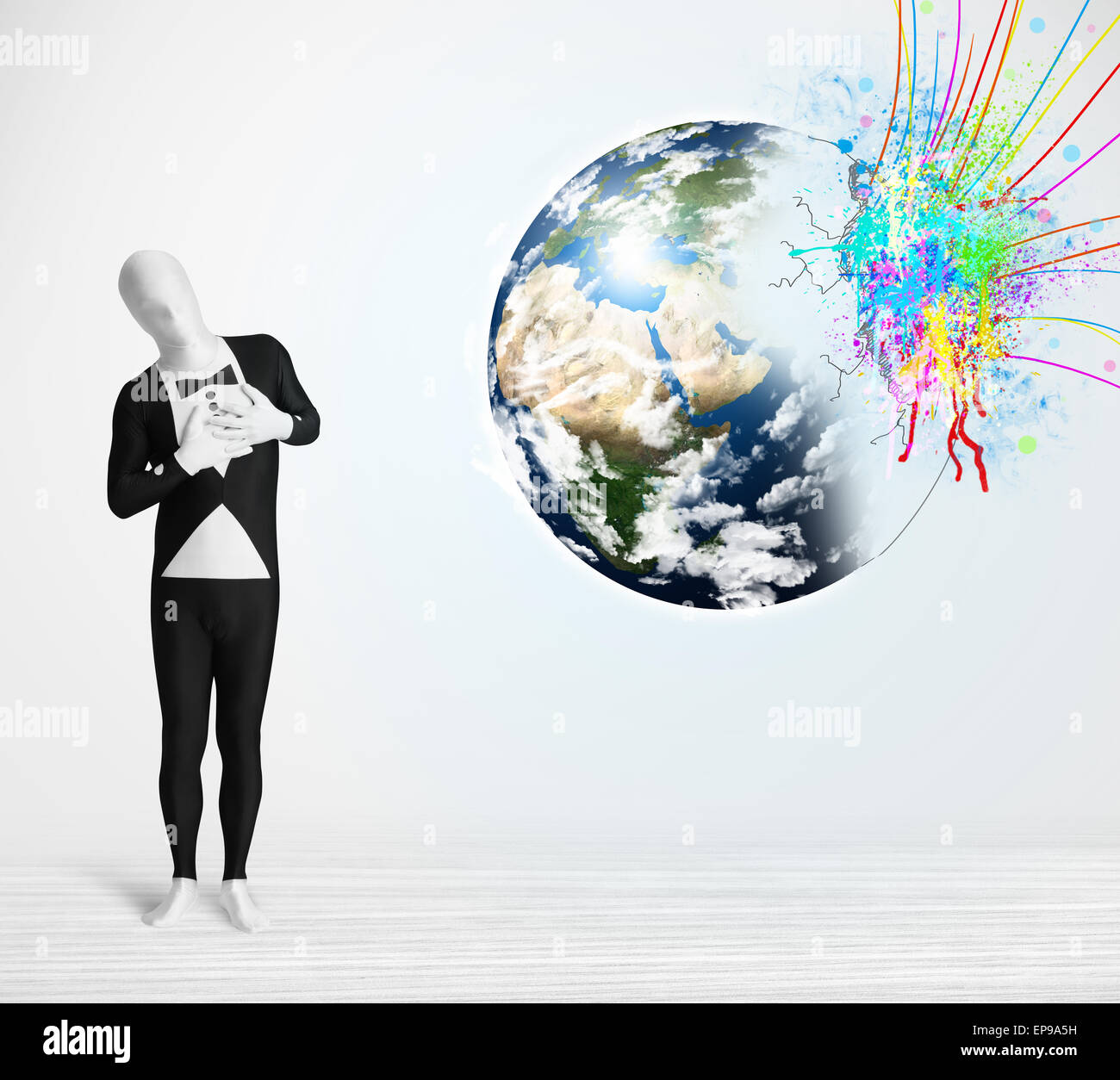 Funny man in body suit looking at colorful splatter earth Stock Photo ...