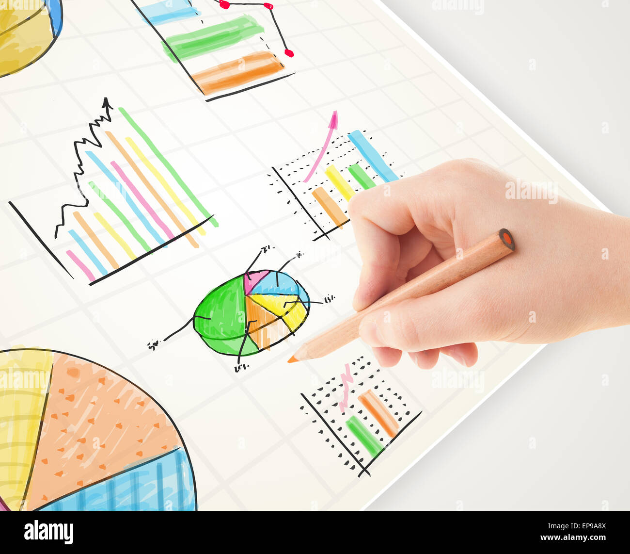 Business person drawing colorful graphs and icons on paper Stock Photo ...