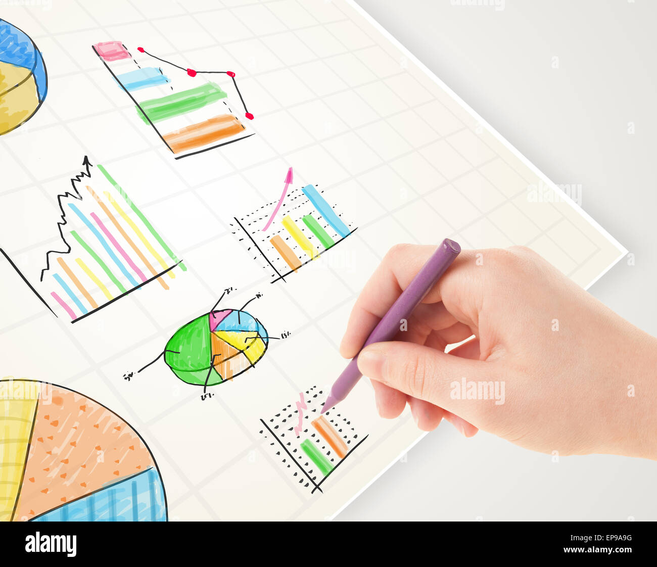 Business person drawing colorful graphs and icons on paper Stock Photo ...