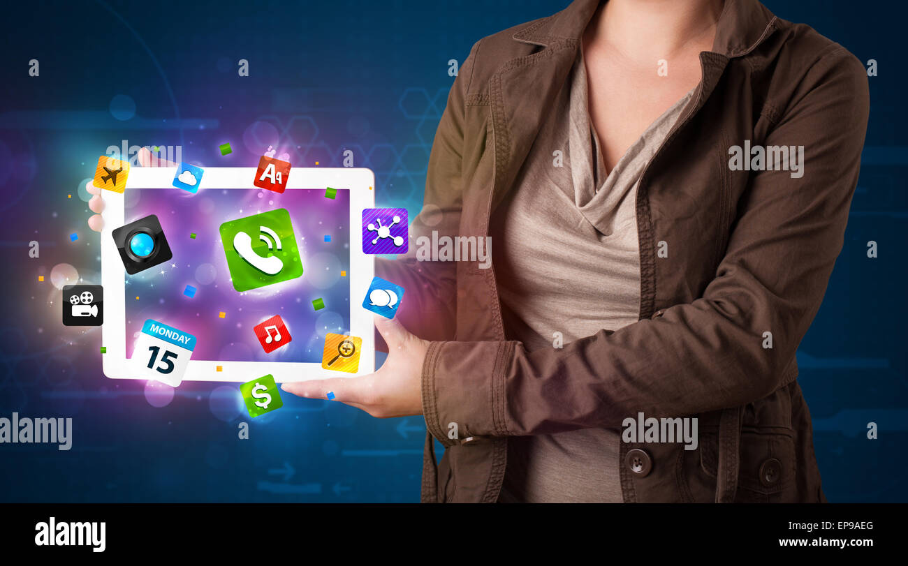 Lady holding a tablet with modern colorful apps and icons Stock Photo ...