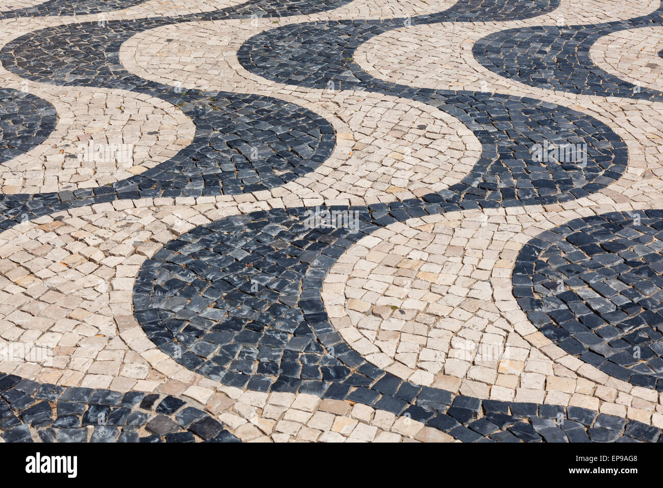 Typical portuguese cobblestone hand-made pavement calçada in Lisbon ...