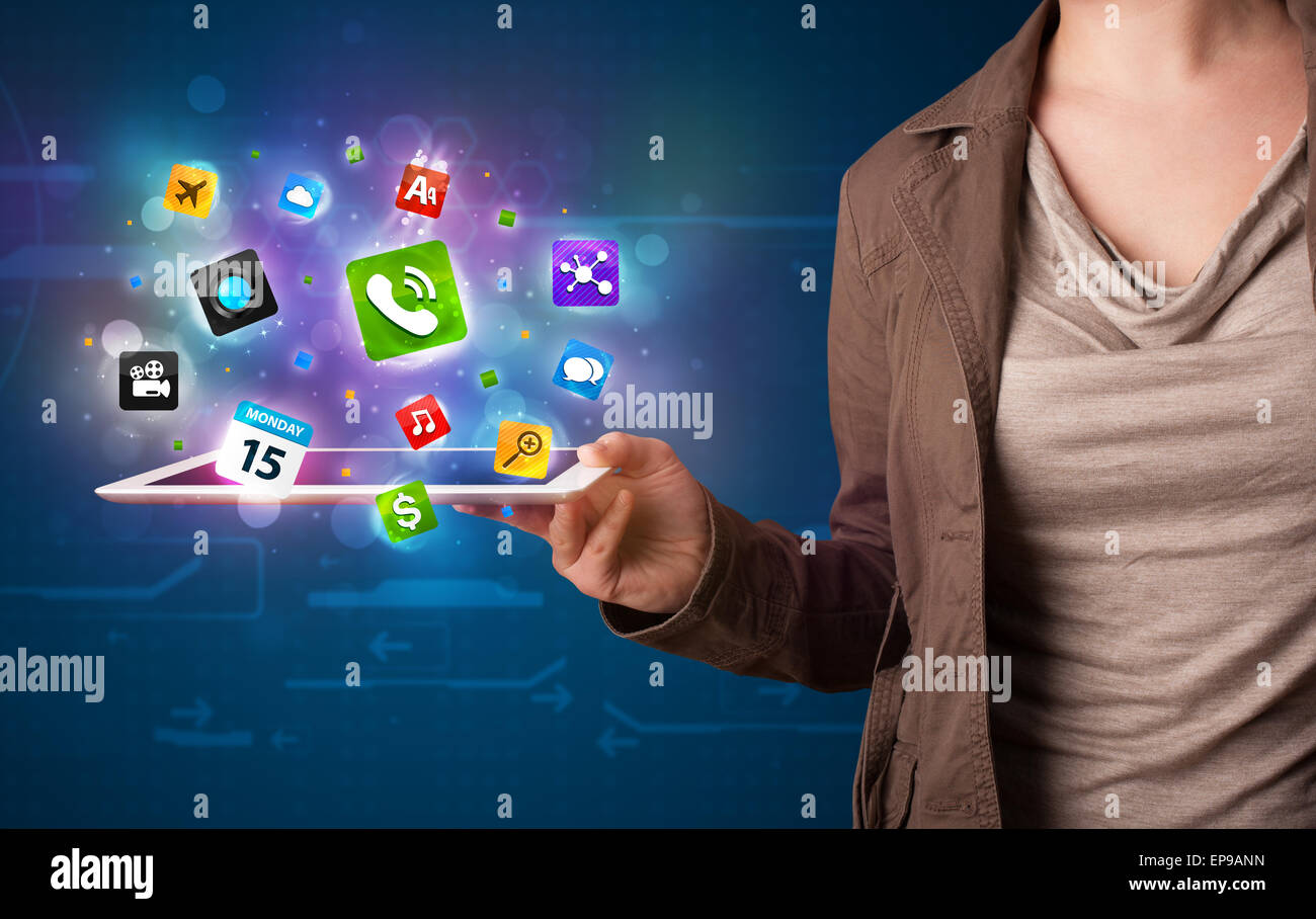 Lady holding a tablet with modern colorful apps and icons Stock Photo ...