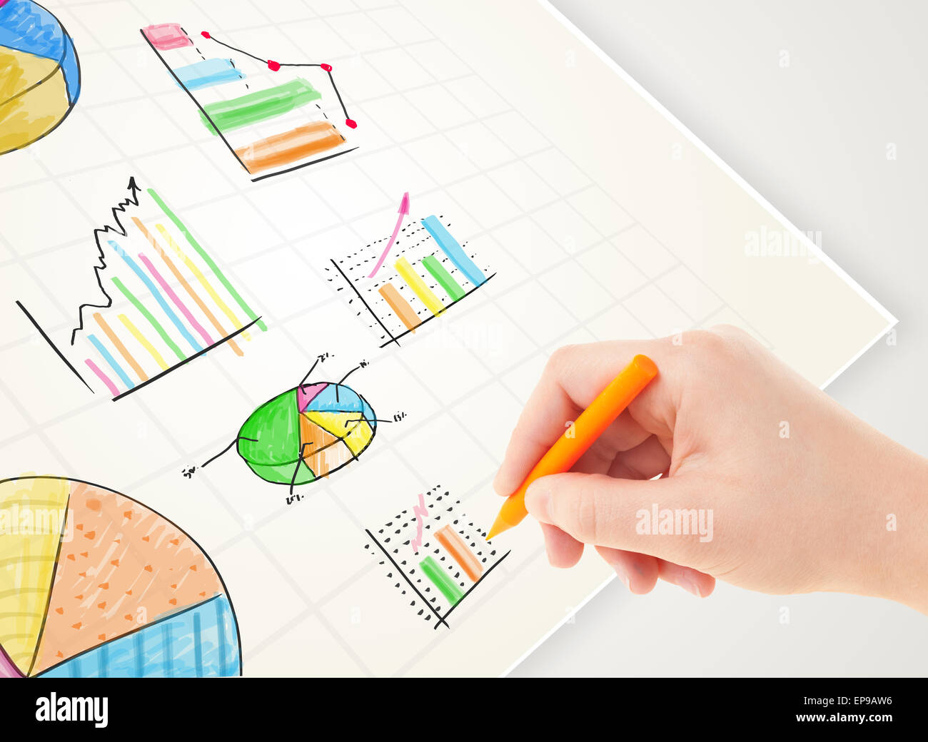 Business person drawing colorful graphs and icons on paper Stock Photo ...