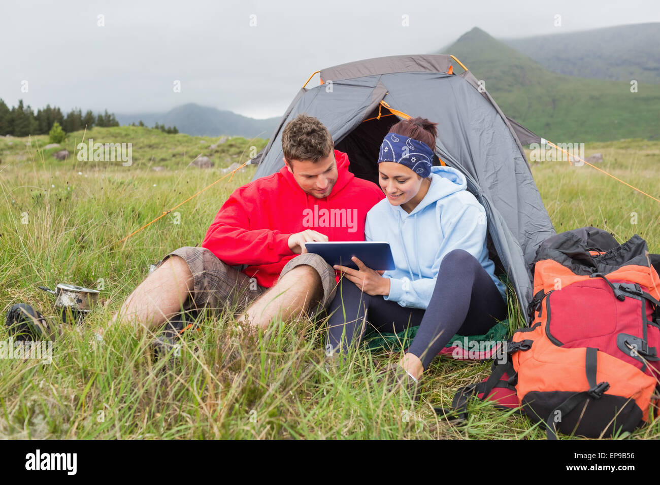 Couple on camping trip using a digital tablet Stock Photo - Alamy