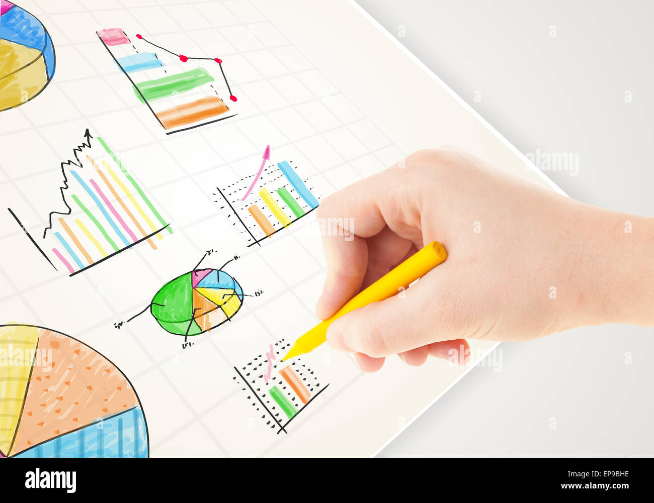 Business person drawing colorful graphs and icons on paper Stock Photo ...