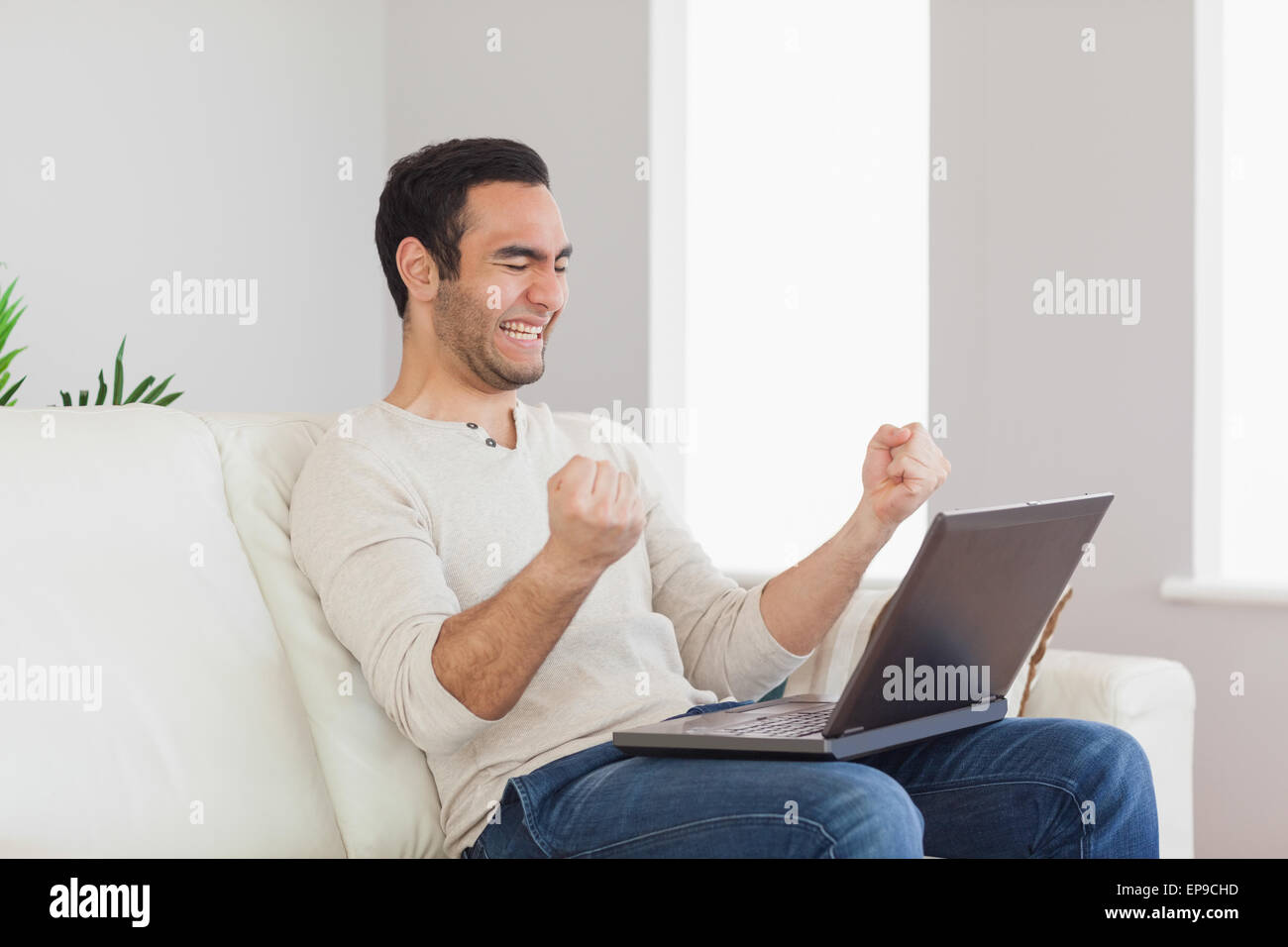 Successful handsome man looking at his laptop Stock Photo - Alamy