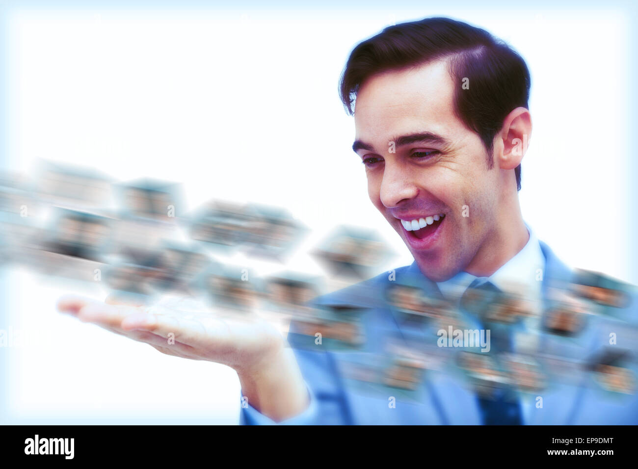 Amused businessman looking at a picture stream Stock Photo - Alamy