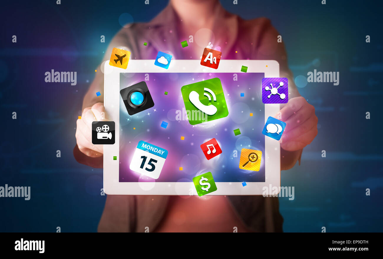 Lady holding a tablet with modern colorful apps and icons Stock Photo ...