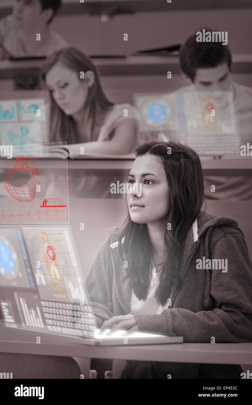 Focused pretty student working on her futuristic laptop Stock Photo - Alamy