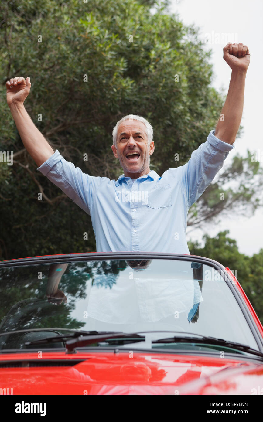 Smiling mature man enjoying his red convertible Stock Photo - Alamy