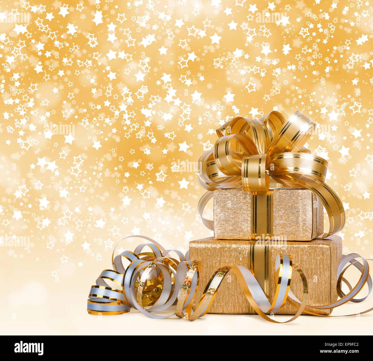 Gift box in gold wrapping paper on a beautiful abstract background ...