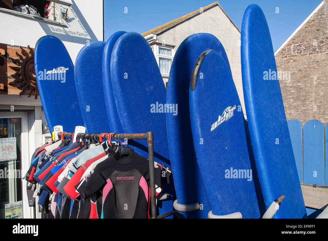 Surfboards and wet suits outside surf shop in Perranporth, a popular ...